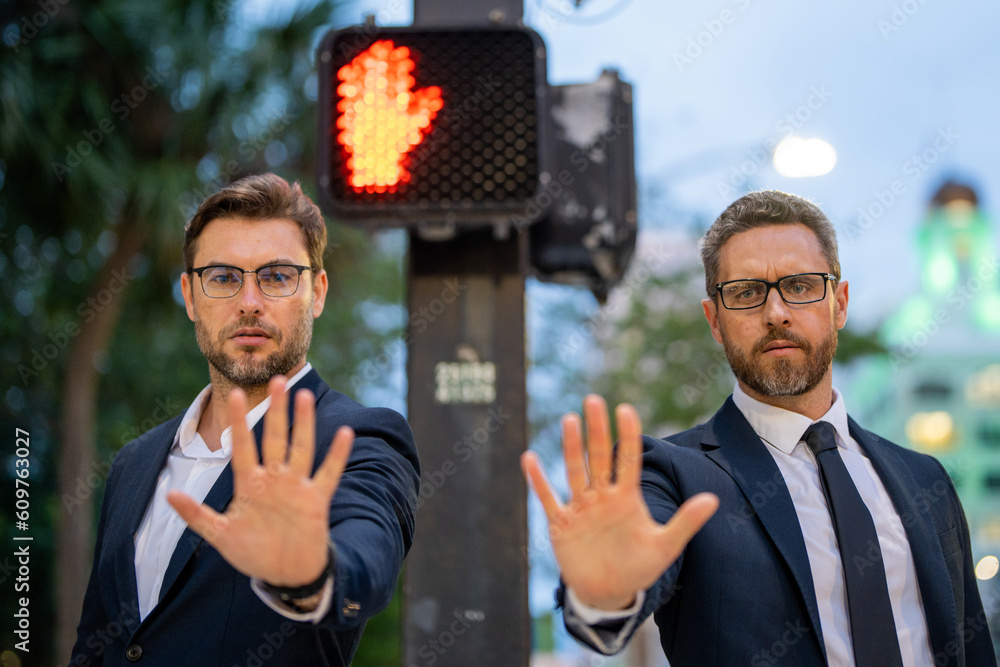Business men doing stop sing with hand. Warning expression with ...