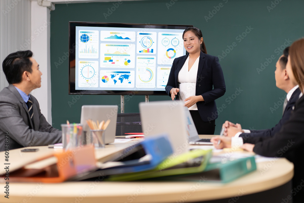 Businesswoman standing in conference room giving statistic presentation ...