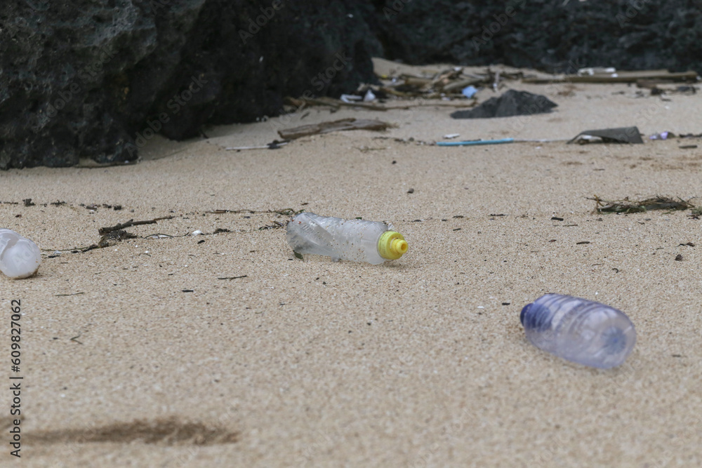 Plastic trash at the sandy beach. Plastic pollution concept. Single-use ...