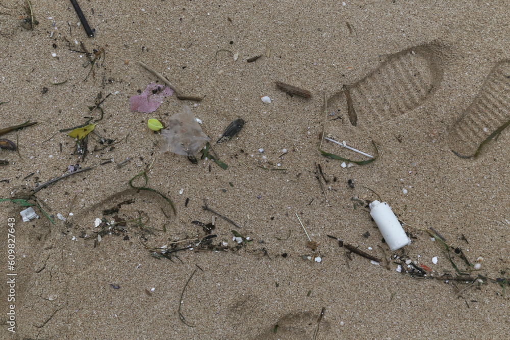 Plastic trash at the sandy beach. Plastic pollution concept. Single-use ...
