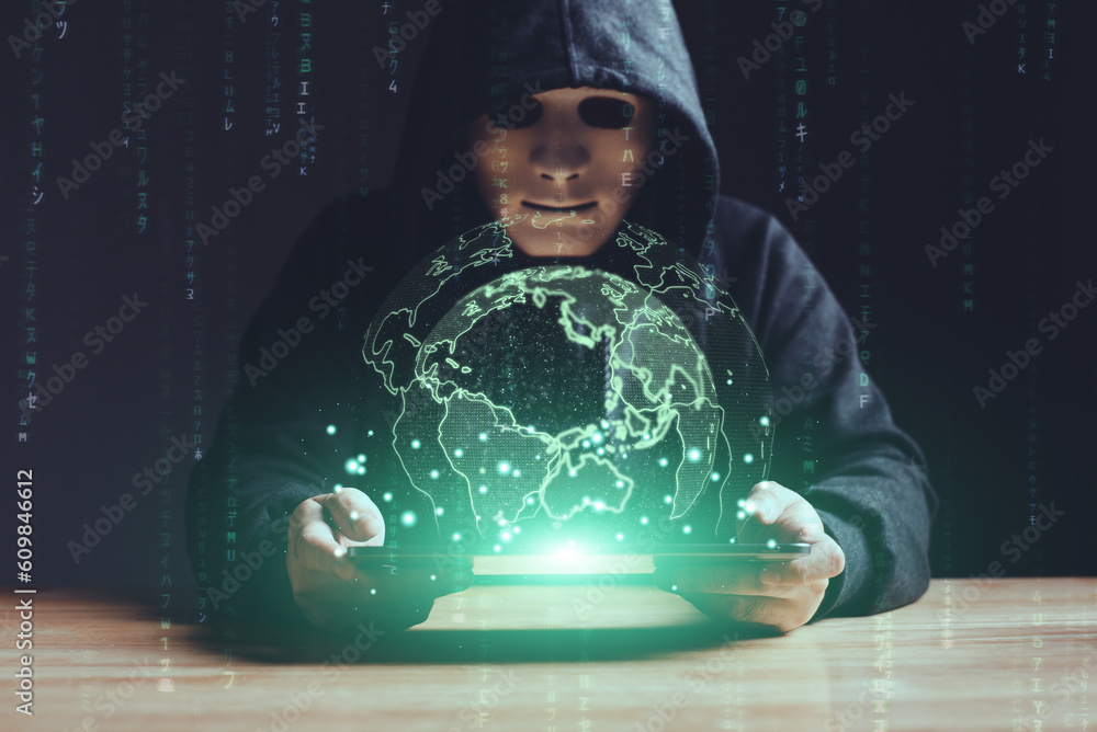 Black hat hacker using tablet on table sensitive data cyber crime hack in black dark room green ...