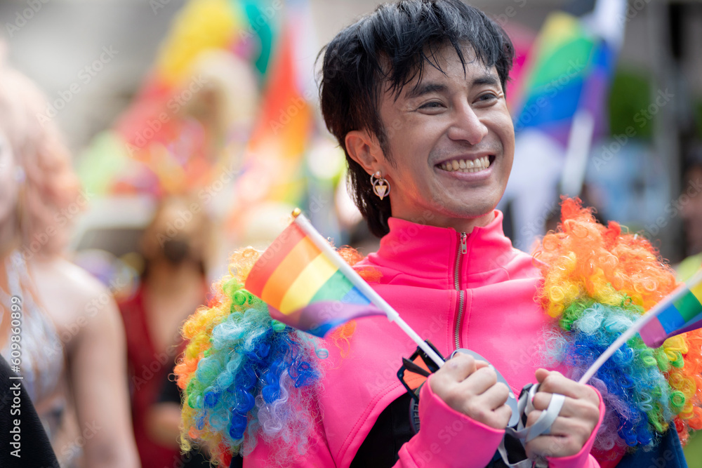 LGBTQ man having fun celebrate pride with flags at the annual Pride ...