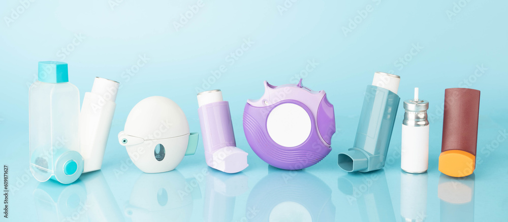 Set of asthma inhalers for asthma and COPD patients on blue background ...