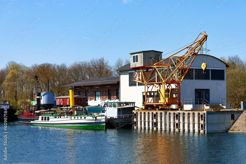 small Cargo harbor with small ships and an old cargo crane without ...