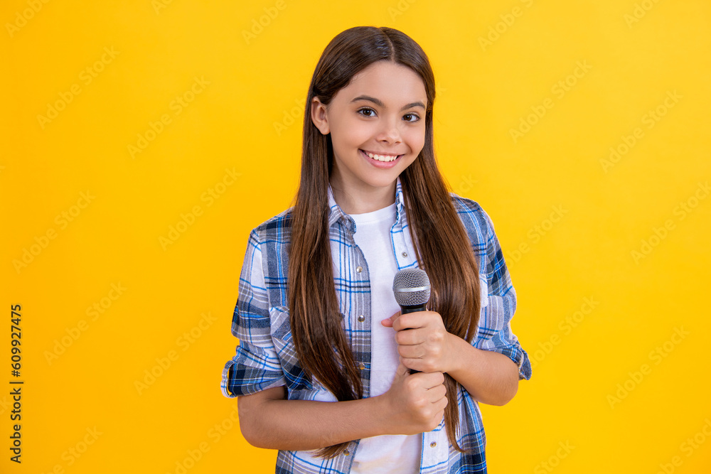 tween girl singer perform karaoke isolated on yellow background. With ...
