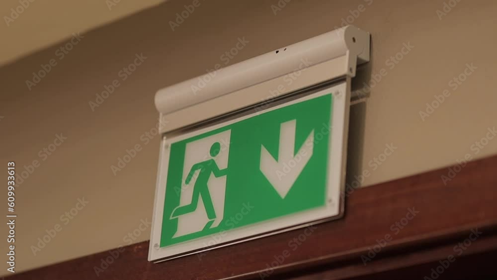 Exit icon, close-up. Direction to the emergency exit. a green light ...
