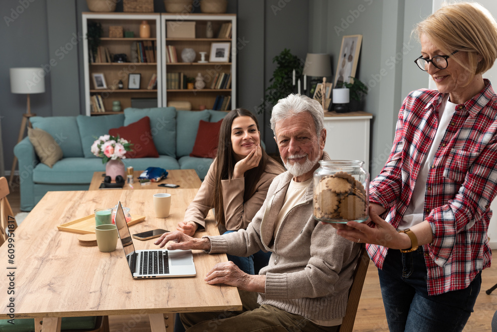 Happy three-generation family hugging sit indoors enjoy time together ...