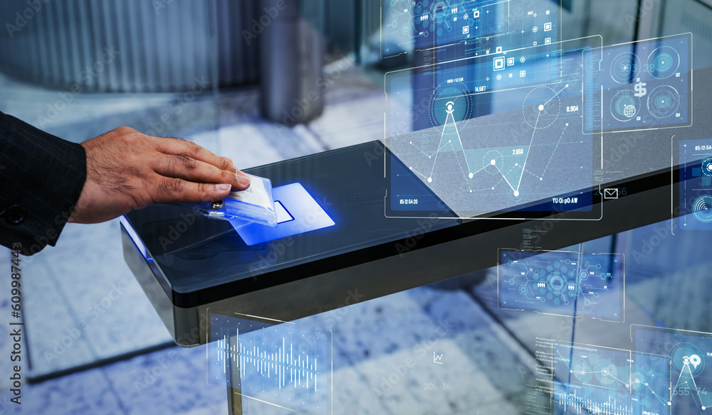 A person touching an ID card to a card reader and digital technology ...