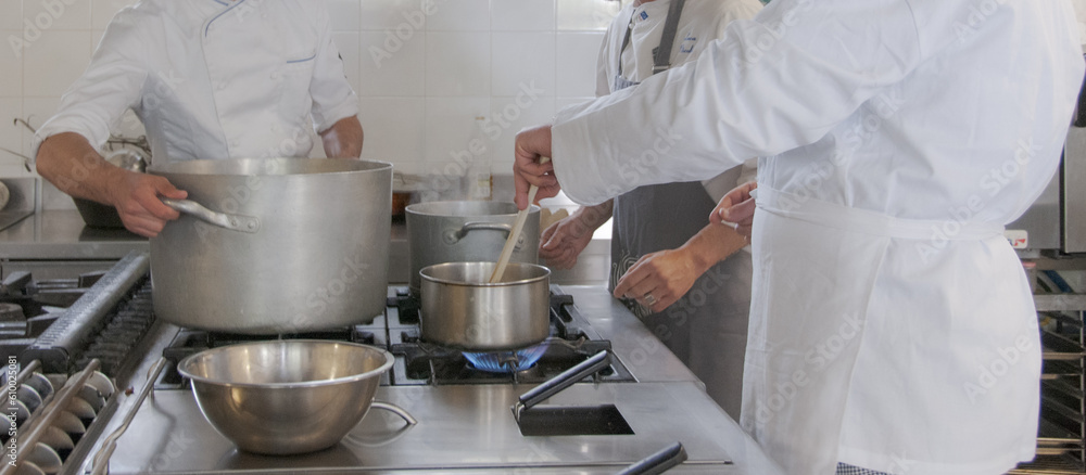 Cooking school chef team helping each other to finish the good food ...
