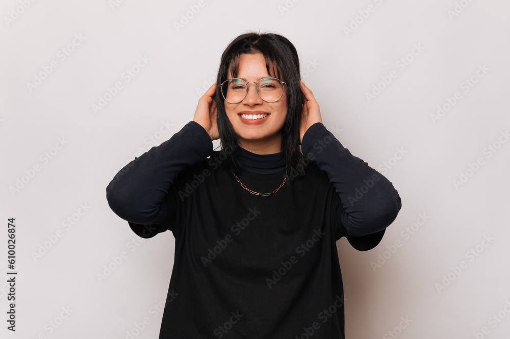 Studio portrait of a wide smiling cute young woman over white ...