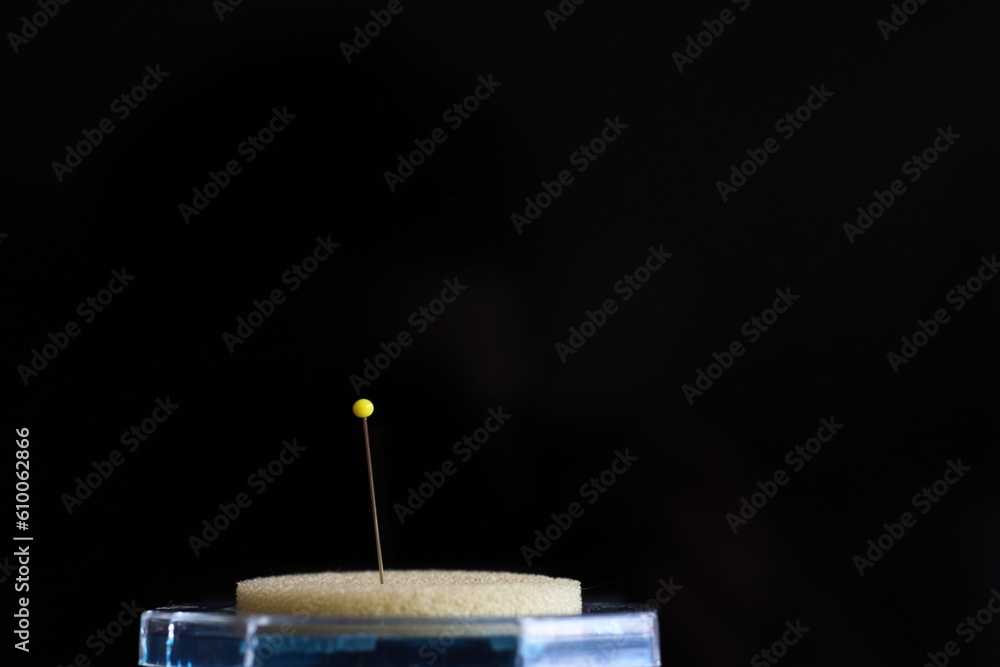 Poster yellow pin stuck in foam in a black background – Wall Art ...