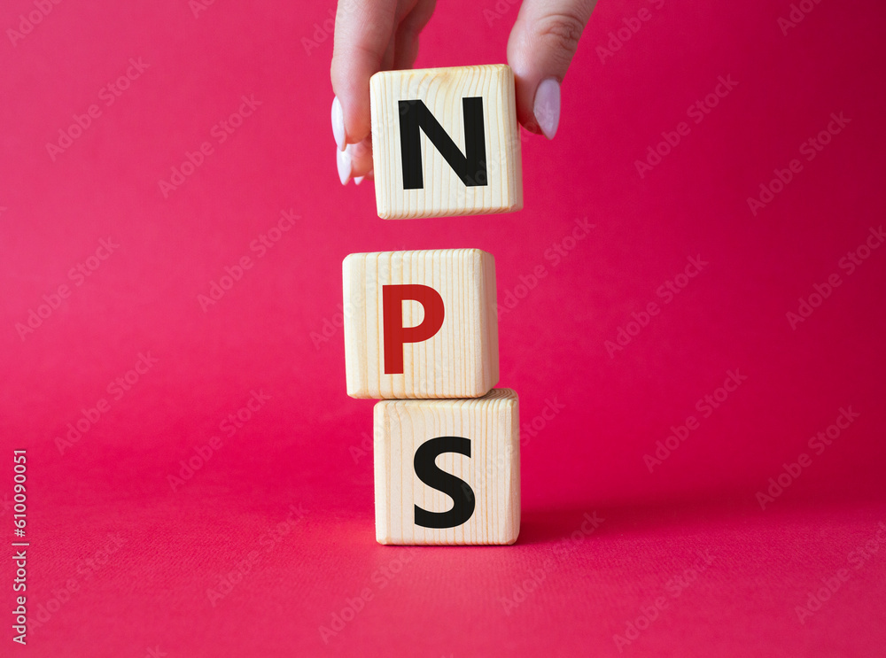 NPS - Net Promoter Score symbol. Wooden cubes with words NPS ...