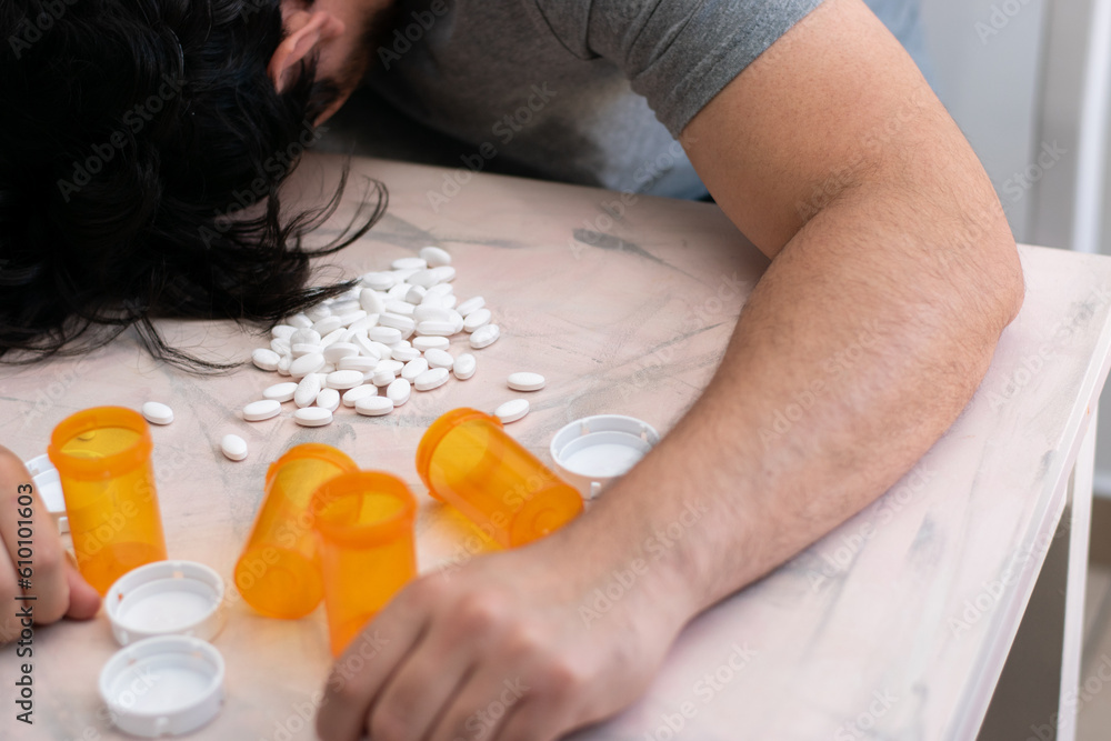 Man passed out on table for overdose of drugs, with empty bottles and ...