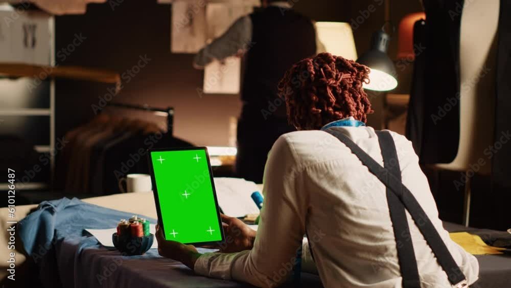 Video Stock Female tailor working with greenscreen on tablet, using ...
