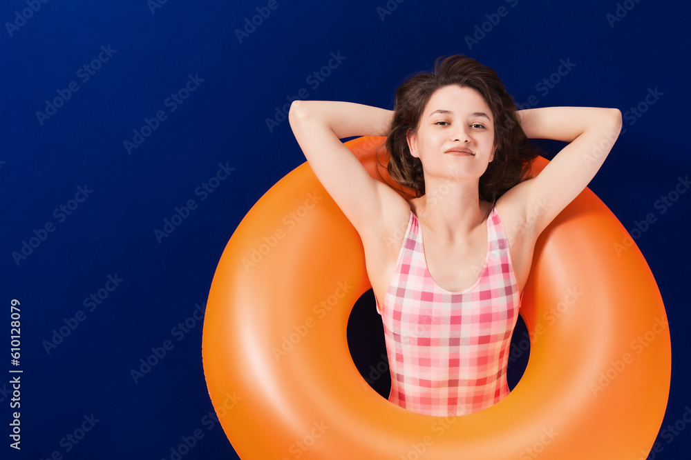 Happy Girl In One Piece Pink Swimsuit Enjoyng And Lying On Inflatable