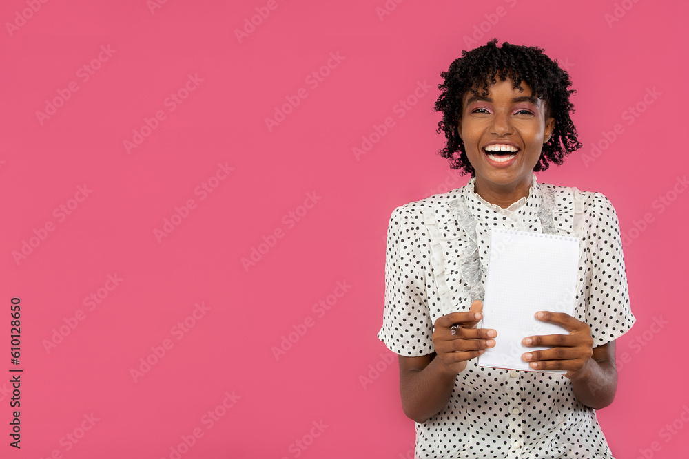 African black woman in a white blouse is very happy holding a notepad ...