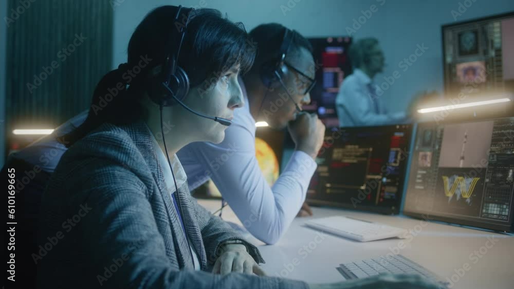 Multiracial flight control operators monitor space mission on multi ...