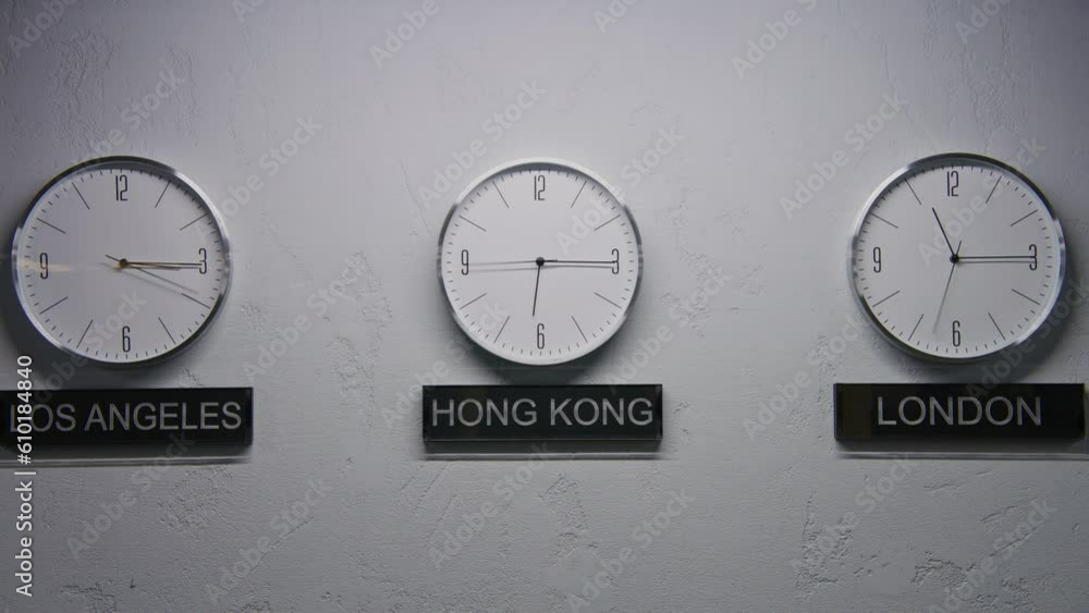 Static shot of walking wall clocks in office with modern design. White ...