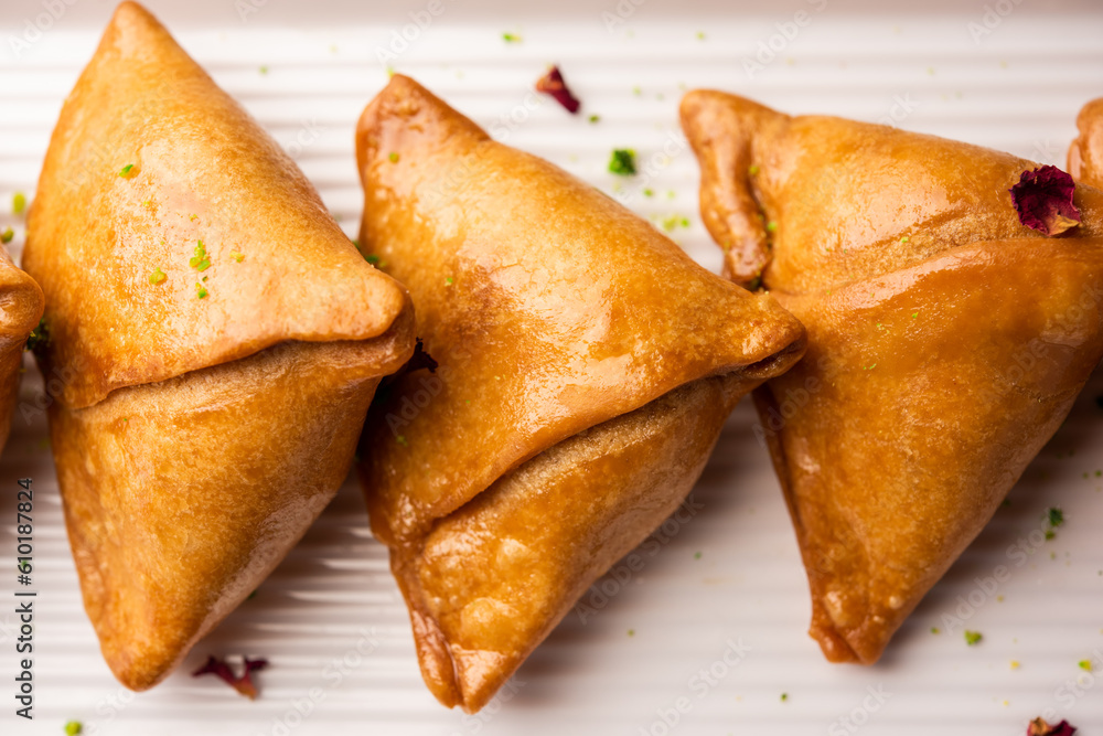 Indian sweet samosa is a Fried pastry soaked in sugar syrup filled with ...