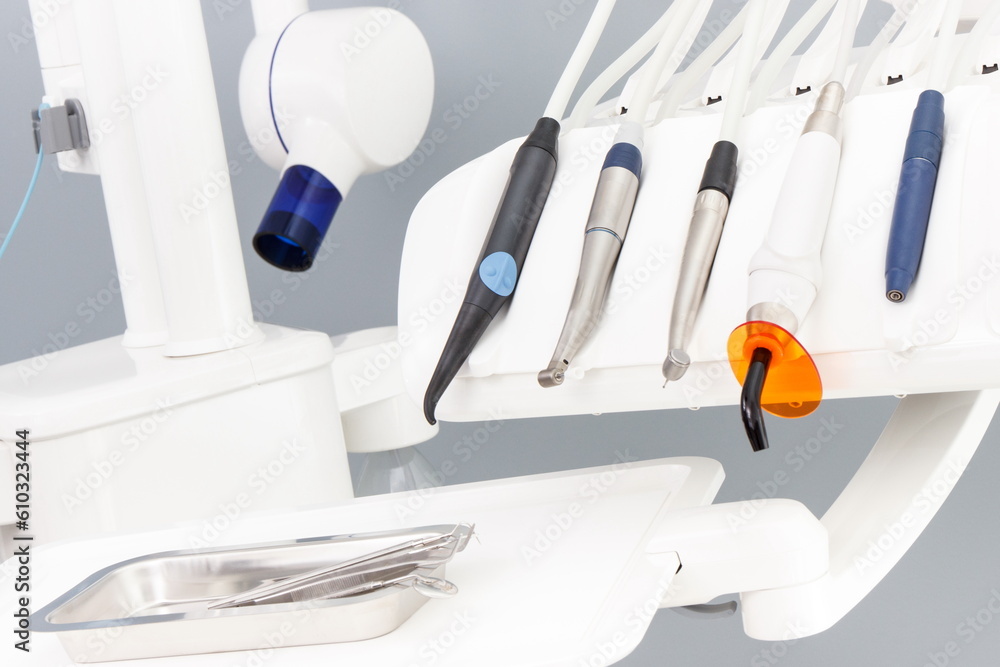 Instruments, set of stainless tools and dental x-ray machine used by ...