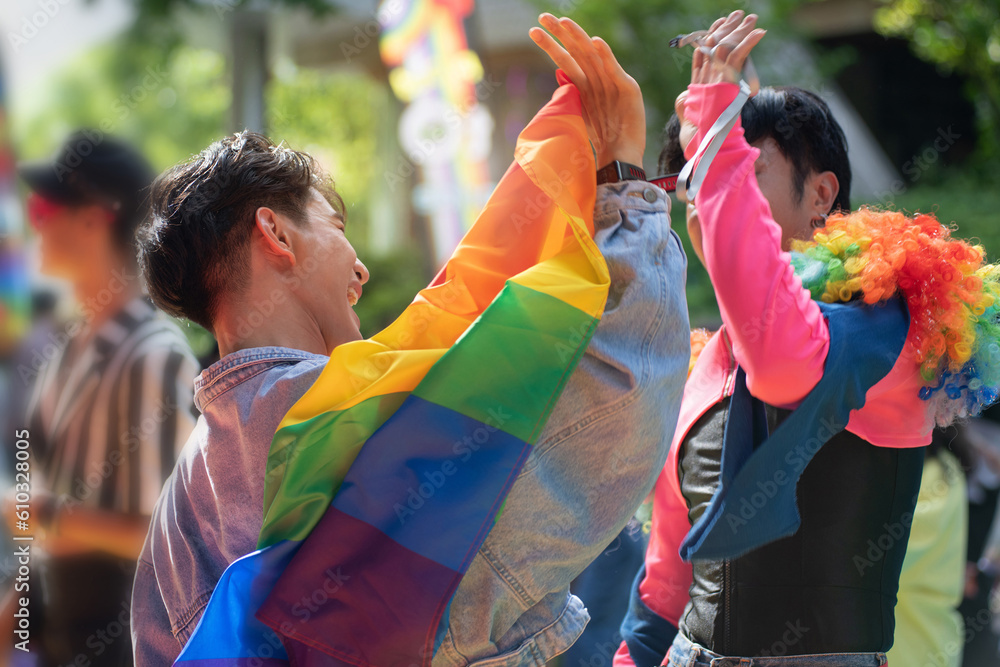 LGBTQ men celebrate their pride by doing high fives during the annual ...