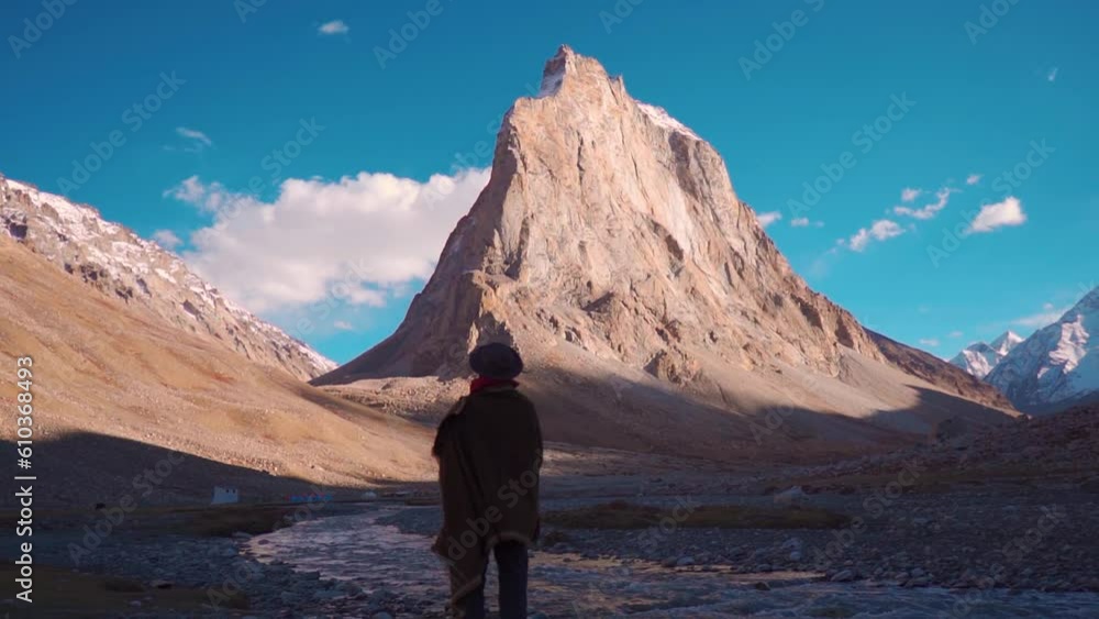 Defocused Indian man staring at the Gonbo Rangjon mountain besides the ...