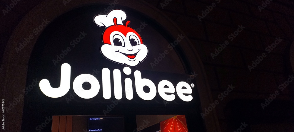 Illuminated sign of a Roman branch of the Filipino fast food chain ...