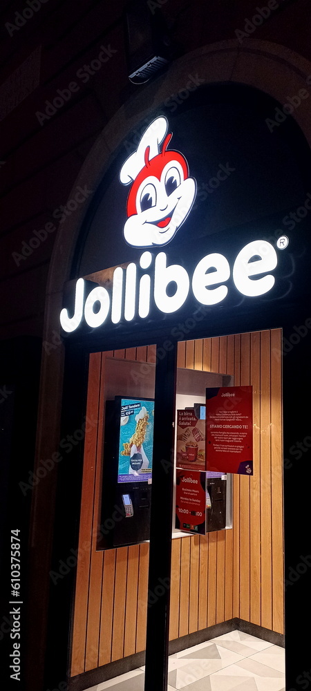 Illuminated sign of a Roman branch of the Filipino fast food chain ...