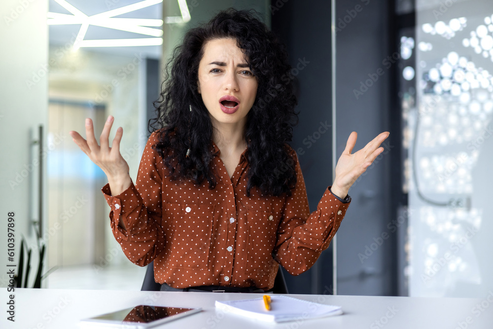 Angry and angry business woman inside office at workplace, latina woman ...