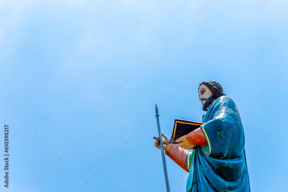 The majestic figure of Jesus Christ stands tall holding a pole and holy ...