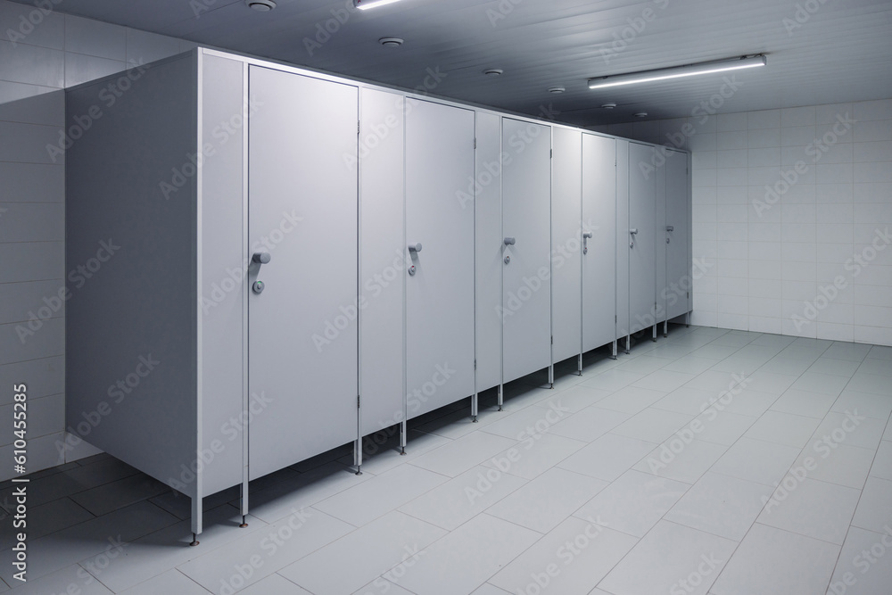 Closed cubicle doors in a public restroom. Public toilet cubicles ...
