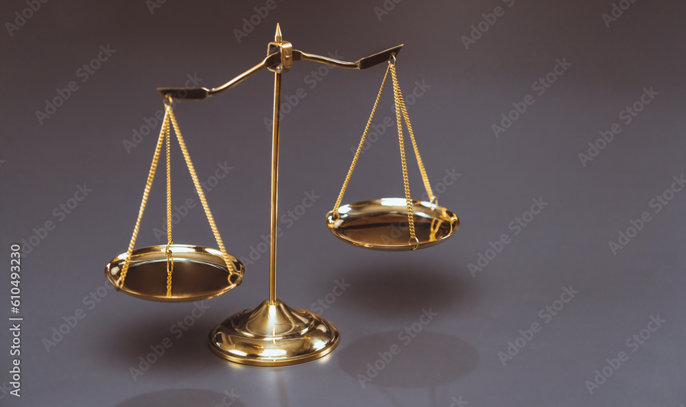 Shiny golden balanced scale in courtroom background as concept justice ...