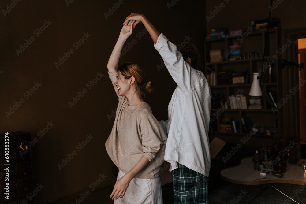Carefree non-binary couple dancing with each other at home Stock Photo ...