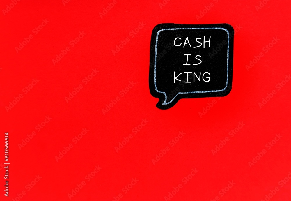 Black sticker on copy space red background with handwritten text CASH ...