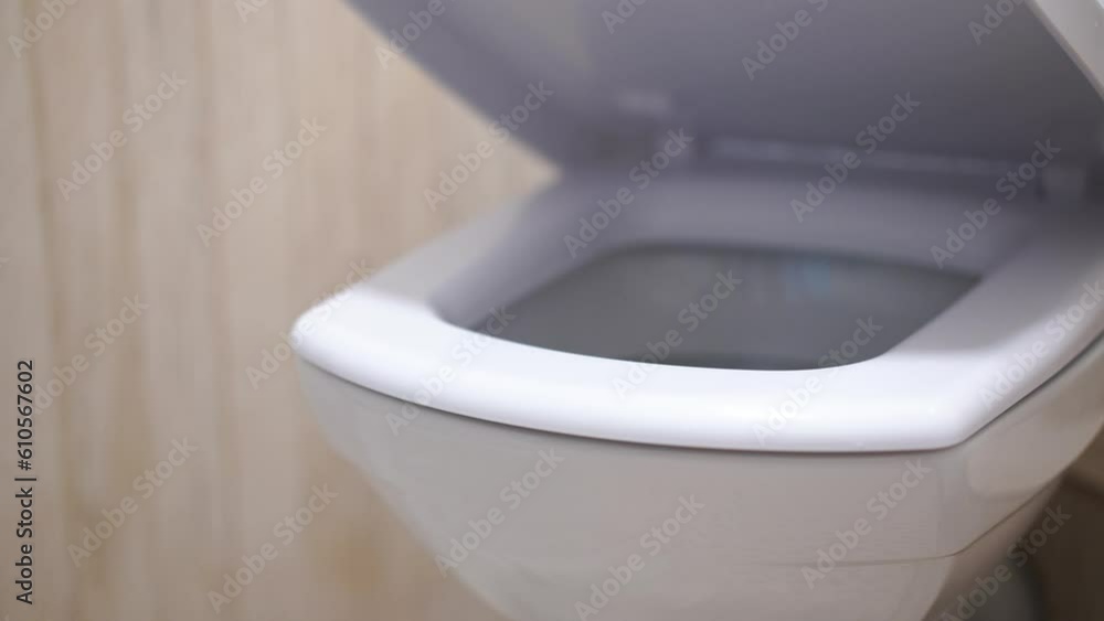 Soft closing of the toilet lid in the bathroom with modern automatic ...