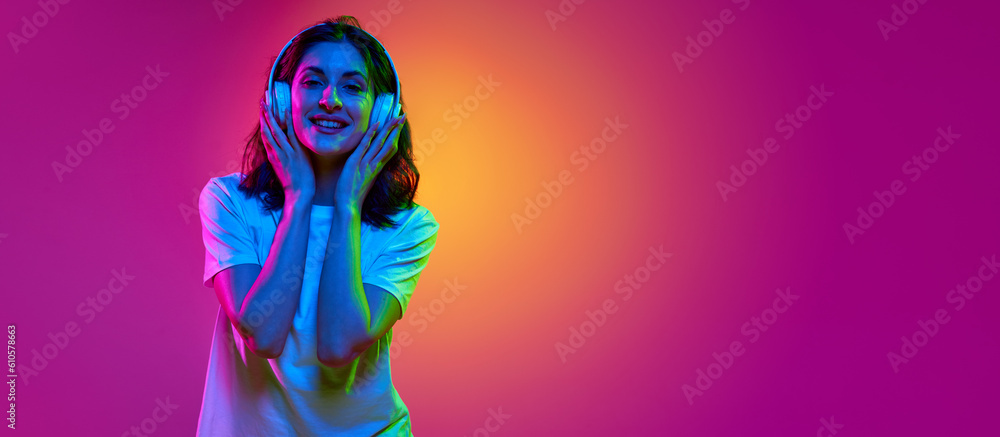 Positive Brunette Woman Wearing Casual Clothes And Headphones Touching