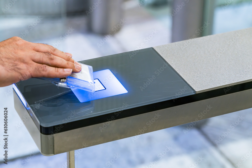 Group of people pass through the office entrance gate after ID card ...