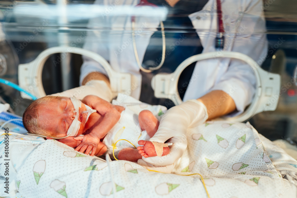Child health, small newborn child lies in pressure chamber connected to ...