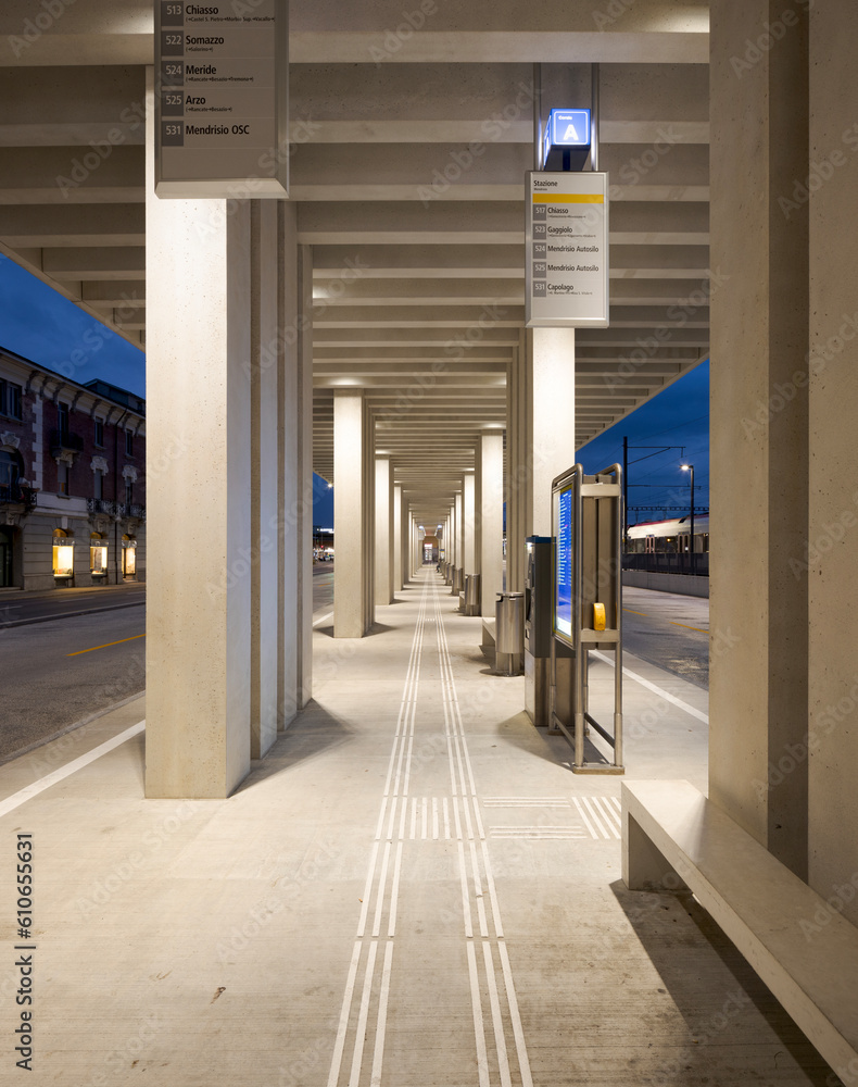 Modern bus stop shelter in Mendrisio. There is a long, lighted corridor ...