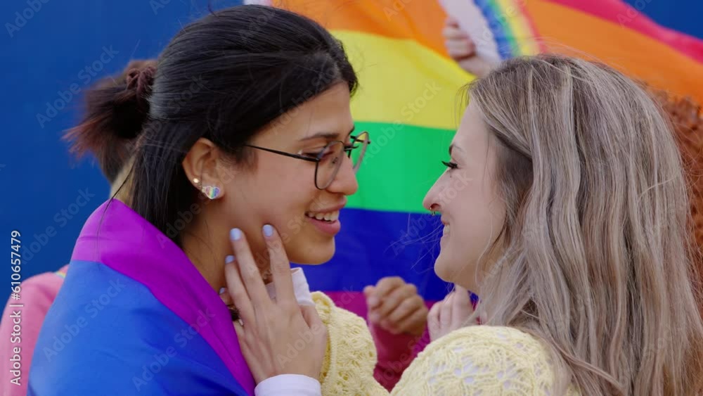 Video Stock Two young diverse girls in love kissing with LGBT group of ...