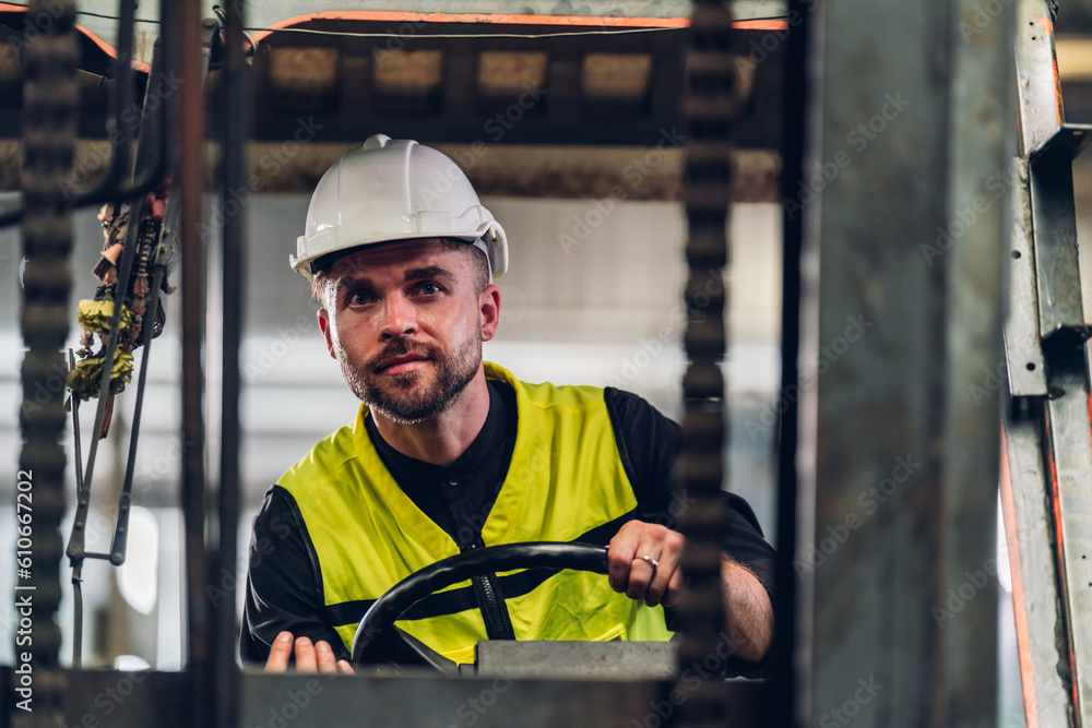 Man worker at forklift driver happy working in industry factory ...