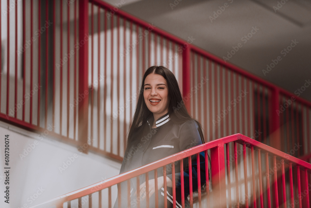 A medical nurse descends the stairs of a modern hospital, showcasing ...