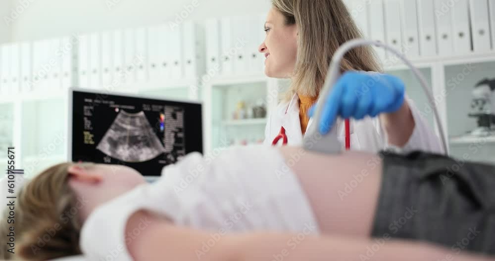 Doctor conducting ultrasound examination of internal organs of child in ...