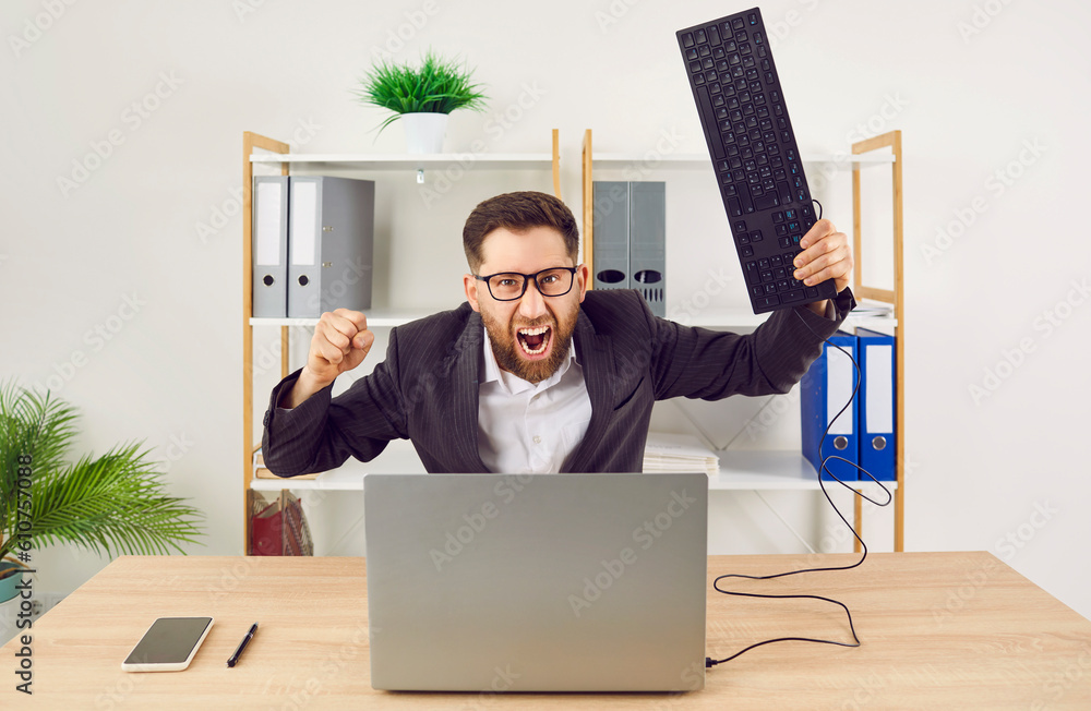 Portrait of an angry shouting business man working on his workplace in ...