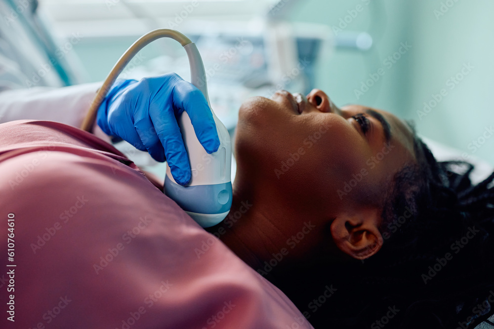 Black female patient during ultrasound thyroid gland examination at ...