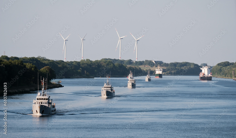 Convoy of the military navy ships with a set of wind generators in the ...