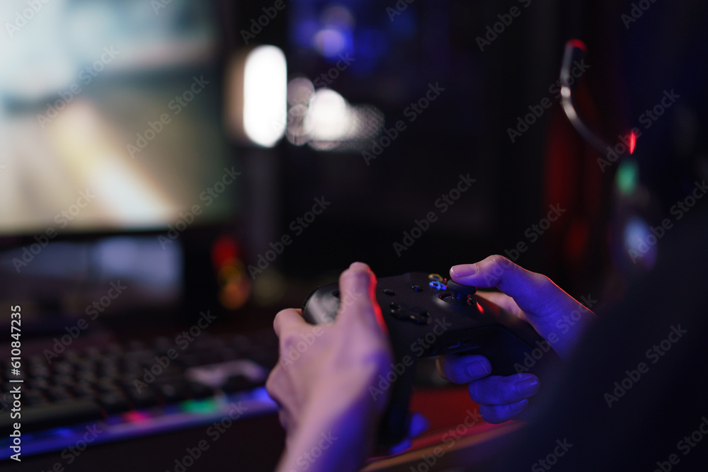 Hand of female cyber hacker gamer holding controller joystick to ...