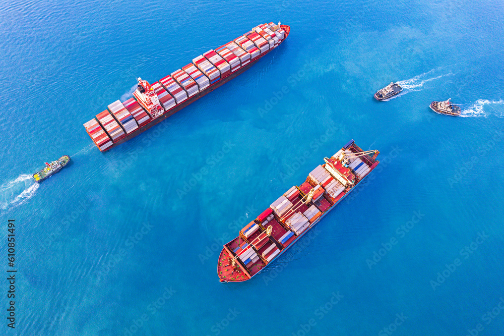 Cargo container ship carrying container and running near Tug boat in ...