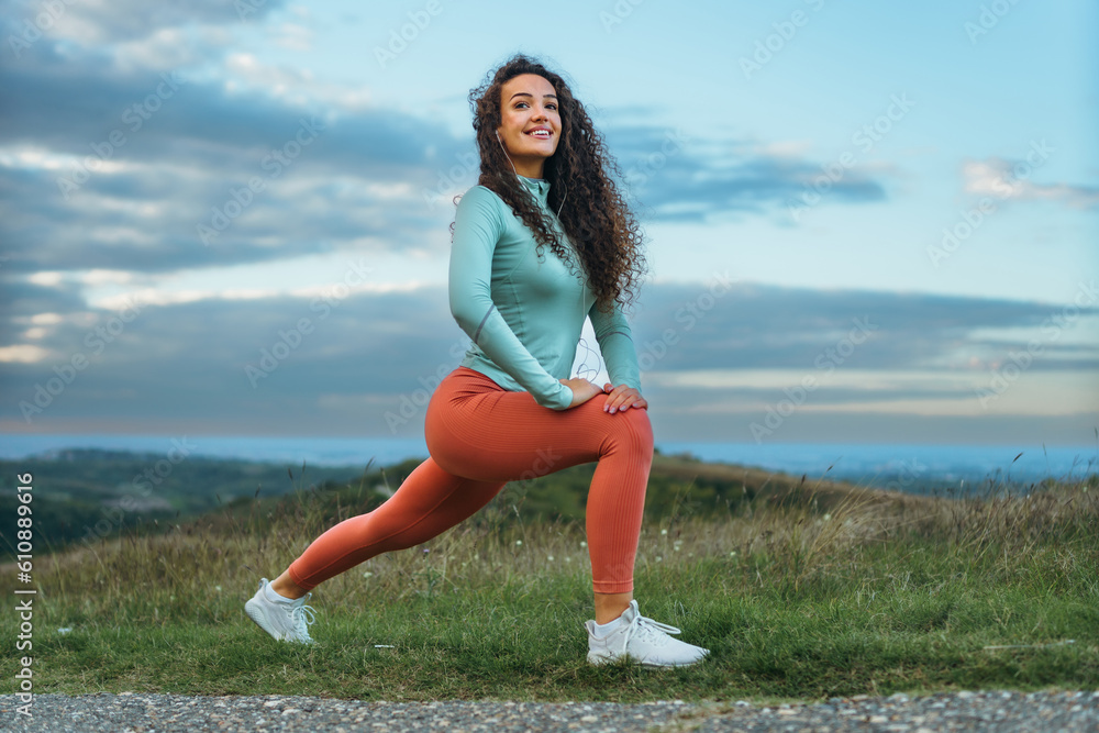 A girl with amazing curls stretching her body and absorbing the ...
