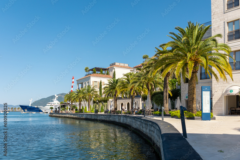 Sea and summer vacation. View of coastal buildings with palm trees on ...